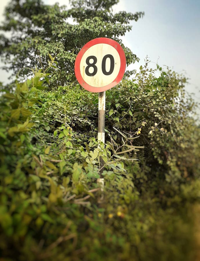 Two Round Red Warning Signs on a Fence Post in Front of a Green Stock ...