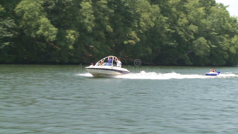 Speedboat pulling a float stock footage. Video of sail - 64521024