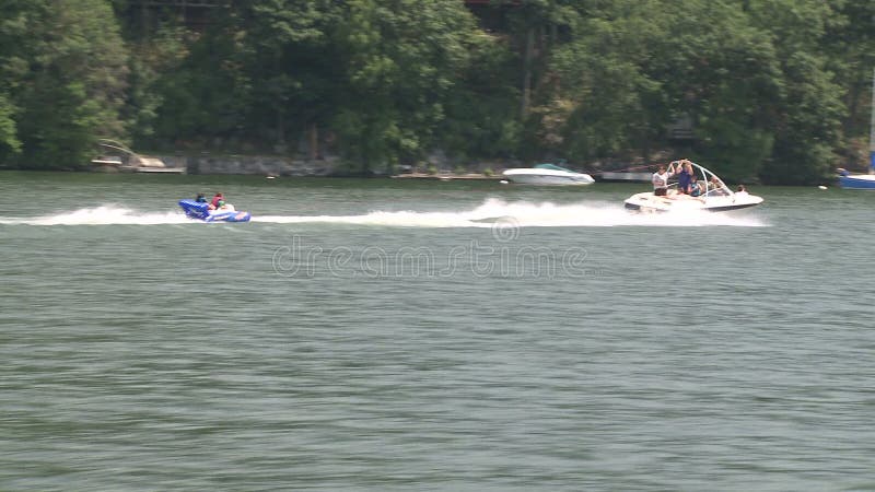 Speedboat pulling a float stock footage. Video of sail - 64521024