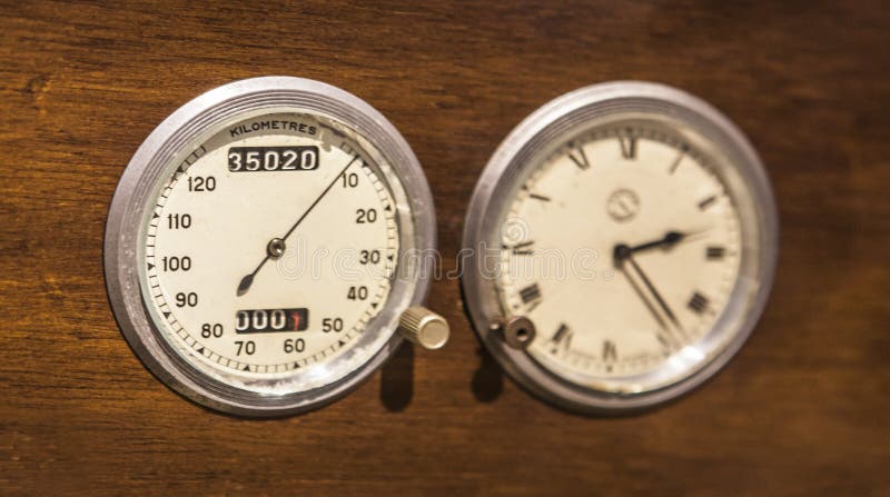 Speedometer and Clock Over Wooden Surface Stock Image - Image of ...