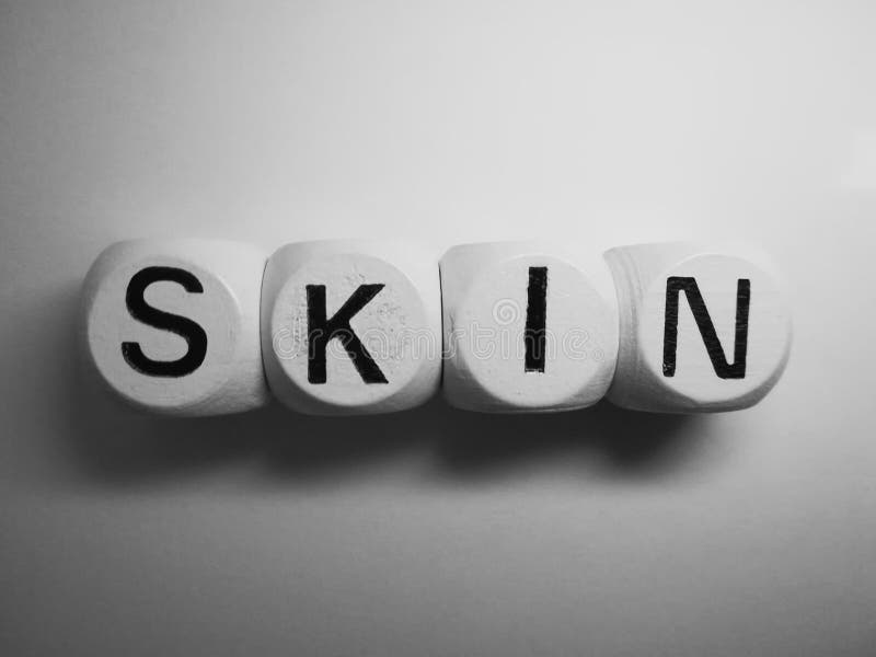Word skin spelled on dice stock photo. Image of apply - 123025400