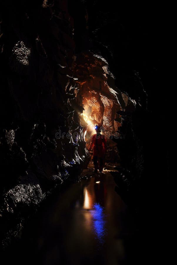 Spelunker exploring a cave stock image. Image of exploring - 67478269