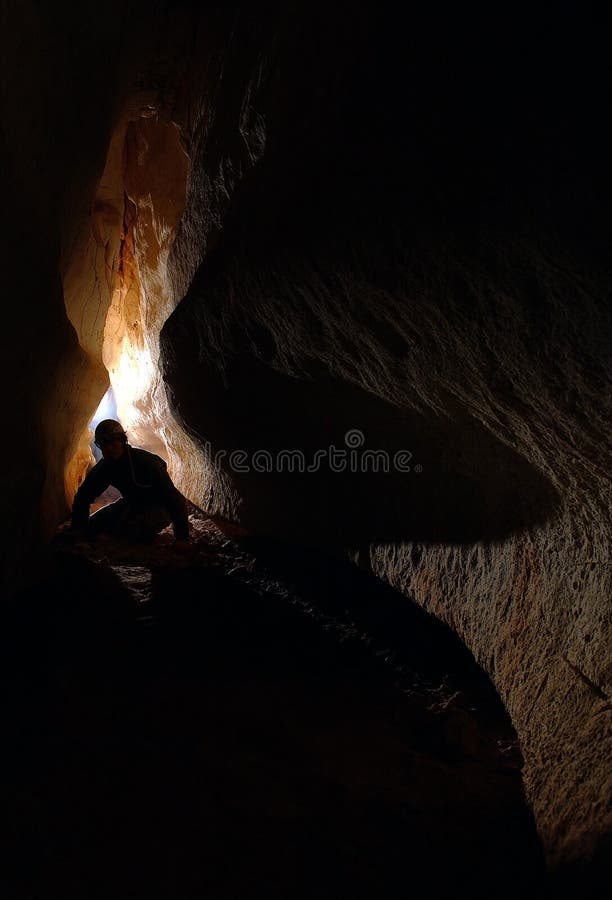 Spelunker exploring a cave stock image. Image of geologic - 51199705