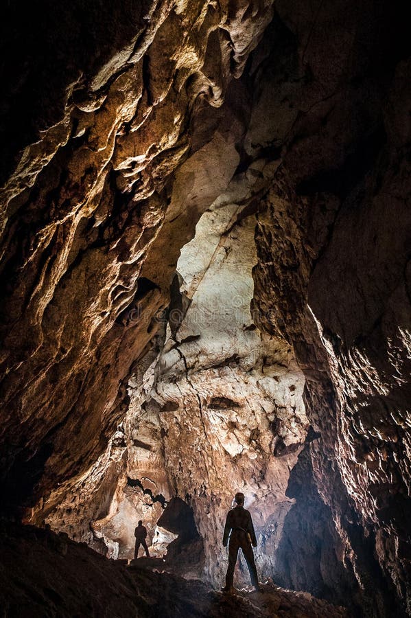 Spelunkers Exploring a Deep Cave Discovering New Undexplored Passage ...