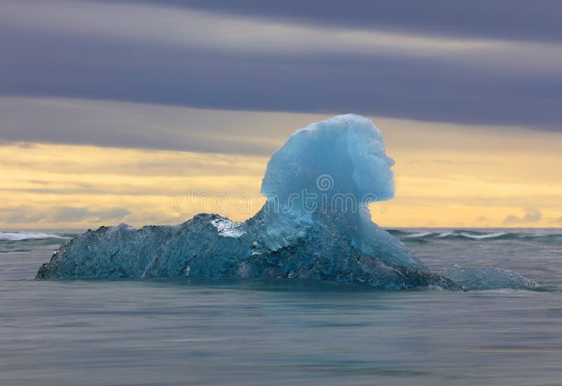 Sphinx Shaped Block of Ice Floats Out To Sea Against a Dramatic Sky ...