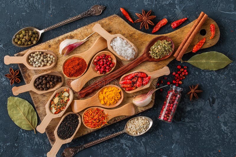 Spices for Cooking on a Cutting Board and in Wooden Spoons Stock Image ...