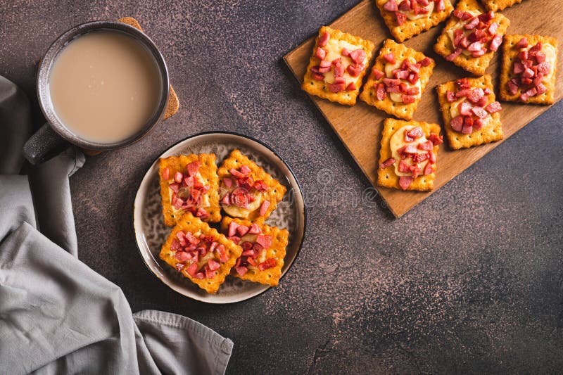 Spicy Baked Crackers with Cheese and Sausage on a Plate on the Table ...