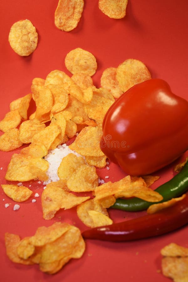 Spicy Chips Scattered on the Surface with Pepper and Salt on a Red ...