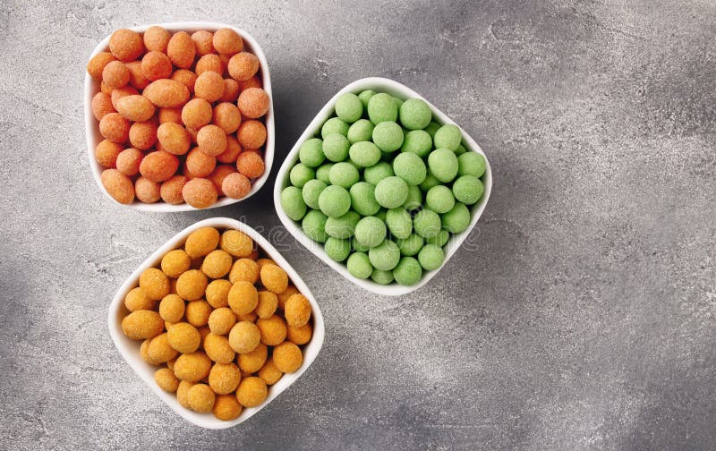 Spicy Coated Fried Peanuts on Gray Background. Snacks and Nuts Stock ...