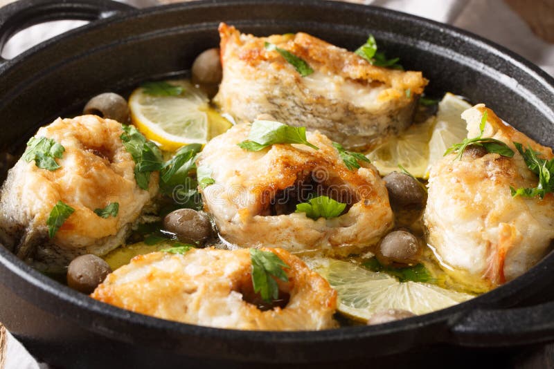 Baked Cod Steaks with Lemon and Olives Closeup in a Pan. Vertical Top ...