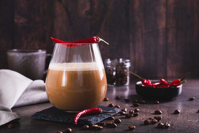 Spicy Coffee Latte with Chili Pepper in a Glass on the Table Stock ...