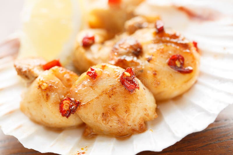 Spicy Fried Scallops in a Shell - Shallow DOF Stock Photo - Image of ...