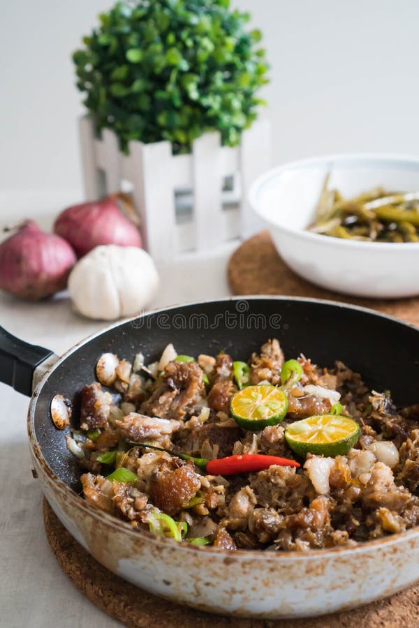 Sizzling Pork Sisig with Raw Egg Stock Photo - Image of oriental, asia ...