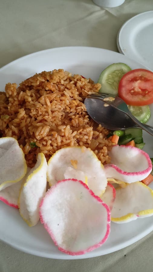 Spicy Indonesian Fried Rice with Rice Cracker and Pickle Stock Image ...