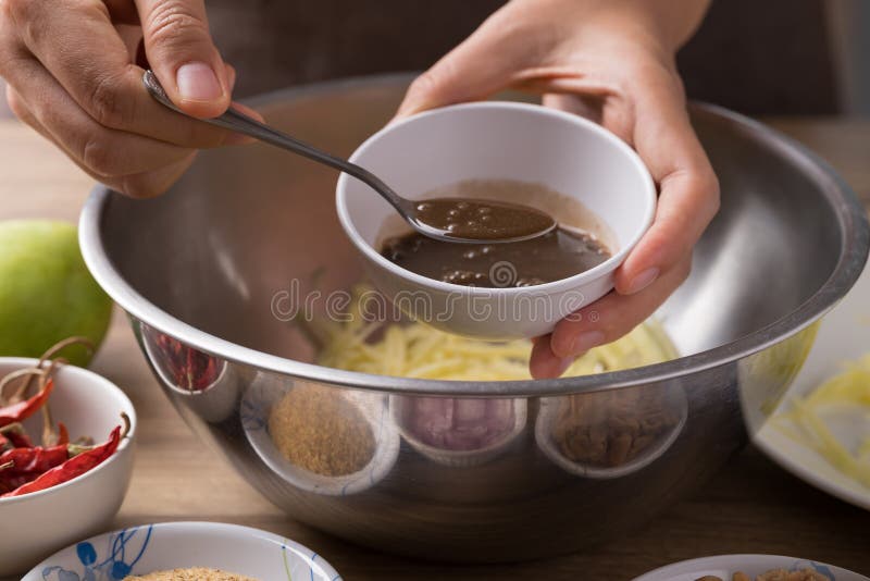 Spicy Mango Salad Cooking, Hand Adding Fermented Fish in Bowl and ...
