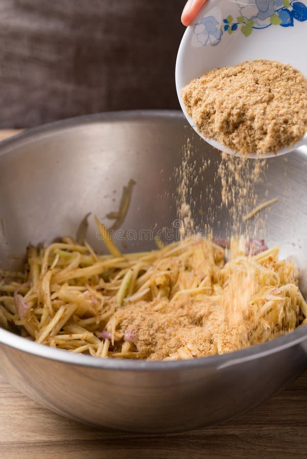 Spicy Mango Salad Cooking, Hand Adding Ground Fish in Bowl and Mixing ...