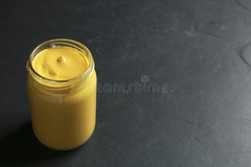 Spicy Mustard in Glass Jar on Black Table. Space for Text Stock Image ...
