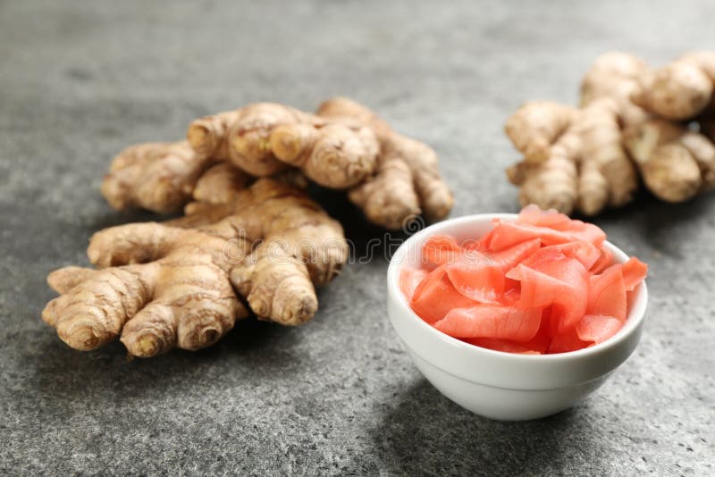 Spicy Pickled Ginger and Root on Grey Table, Closeup Stock Photo ...