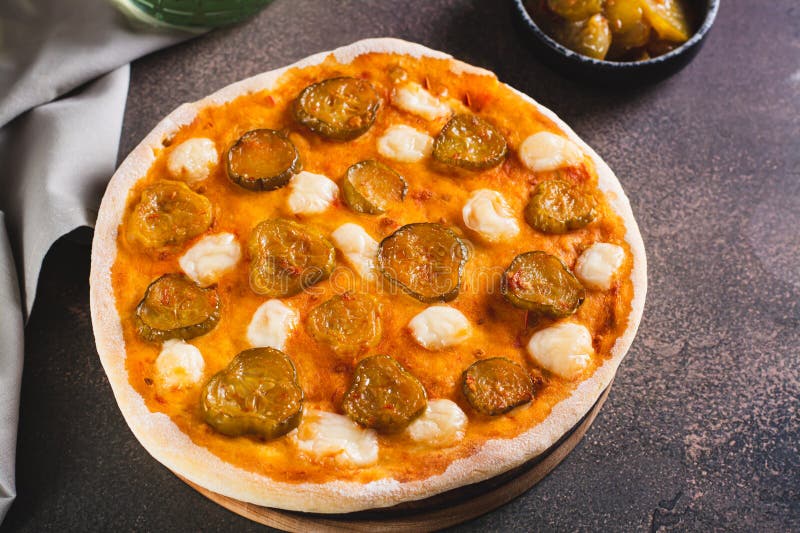 Spicy Pizza with Cheese and Pickles on a Wooden Board on the Table ...