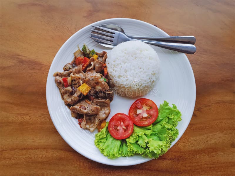 Spicy Stir Fried Garlic Pork with Rice on White Plate Stock Photo ...