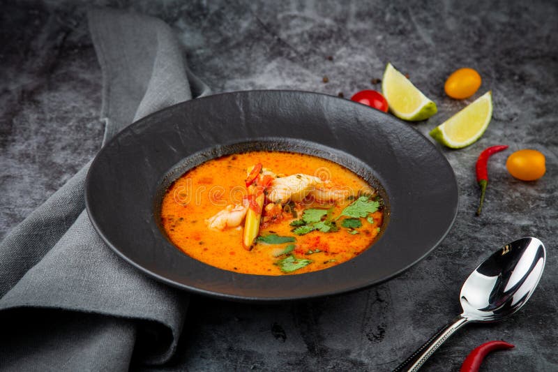 Spicy Tom Yum in a Black Plate with Greens, Side View Stock Image ...