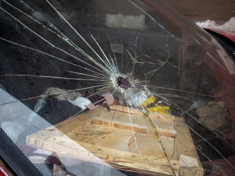 A Spiderweb of Cracks Spreads from the Bullet-like Hole in the ...