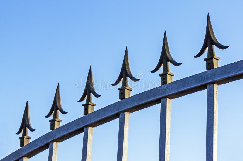 Spikes on Galvanised Gate Against Blue Sky Stock Image - Image of ...