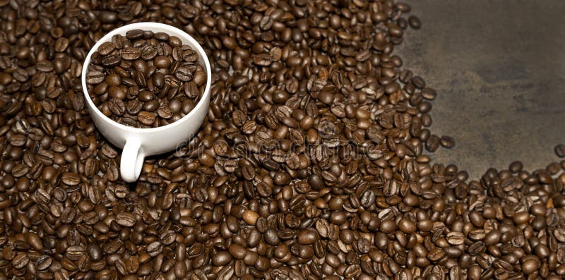 Spilled Coffee Beans, a Cup of Coffee and Coffee Beans on the Table ...
