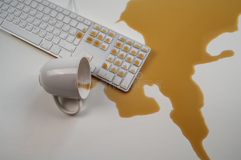 Spilled Cup of Black Coffee on Computer Keyboard on White Table ...