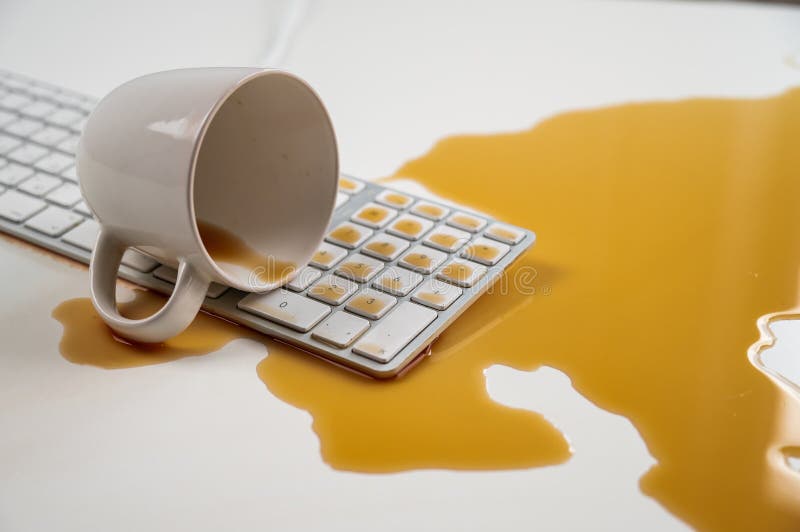 Spilled Cup of Black Coffee on Computer Keyboard on White Table. Stock ...