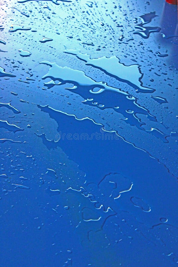 Spilled Liquid on a Blue Table Stock Image - Image of glass, alcohol ...