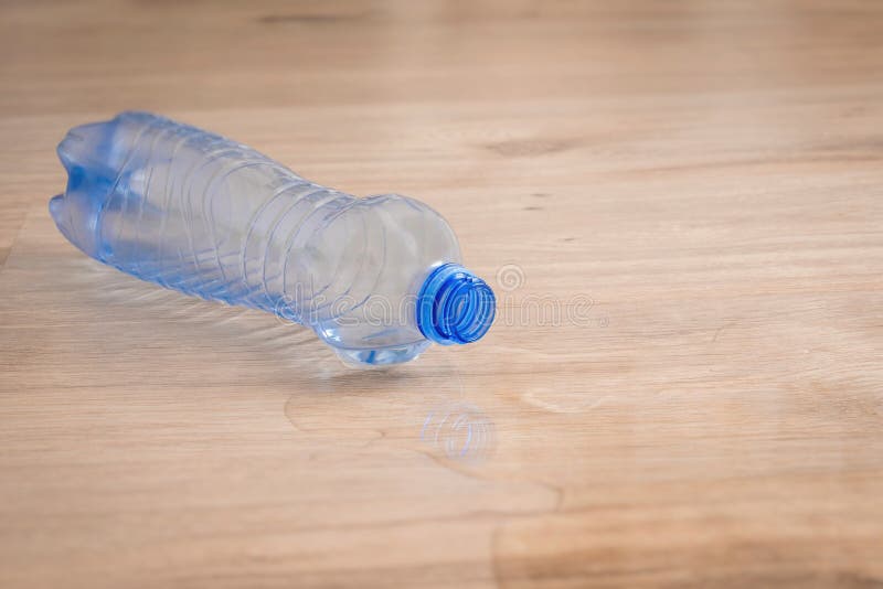 Spilled Water and Fallen Bottle on Wooden Laminate Floor Stock Image ...