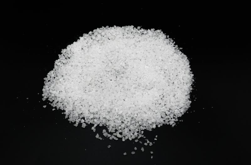 Spilled White Sea Salt on a Black Background. Transparent Pebbles on a ...
