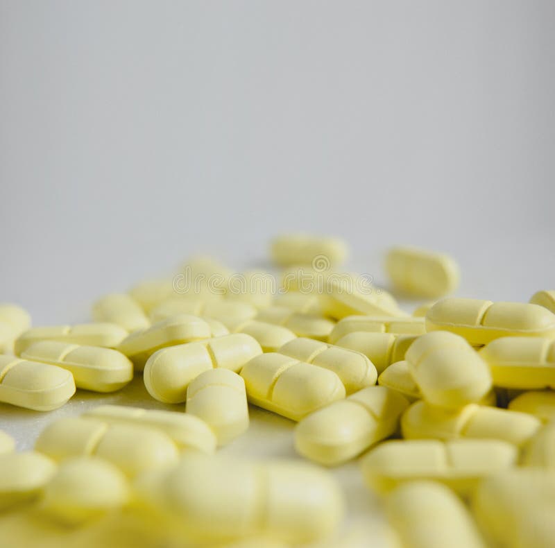 Spilled Yellow Pills and a Lot of Copyspace Stock Image - Image of ...