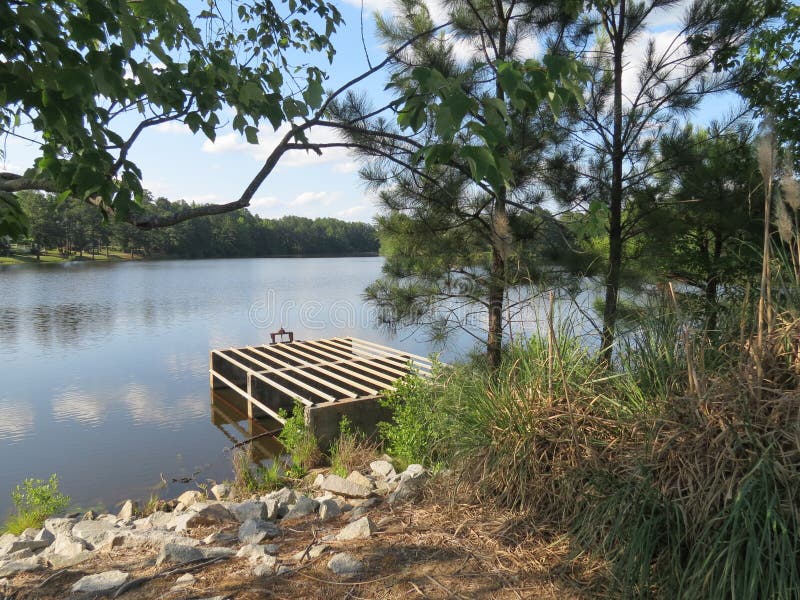 Spillway on Lake by Rocky Shore and Trees Stock Photo - Image of ...