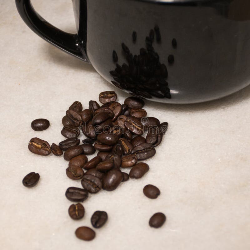 Spilt Coffee Beans beside a Black Mug Stock Photo - Image of bean ...