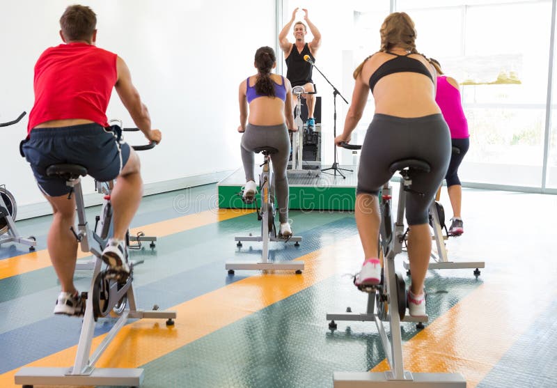 Spin Class Working Out with Motivational Instructor Stock Image - Image ...