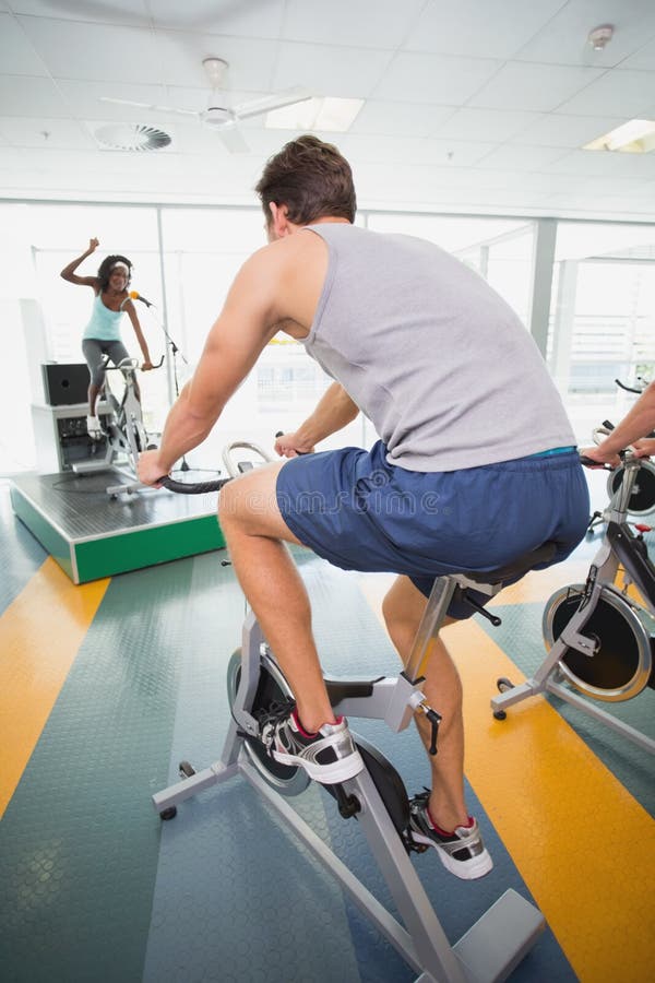 Spin Class Working Out with Motivational Instructor Stock Image - Image ...