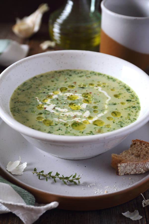 Spinach Cream Soup in Ceramic Plat, Garlic and Olive Oil Stock Photo ...