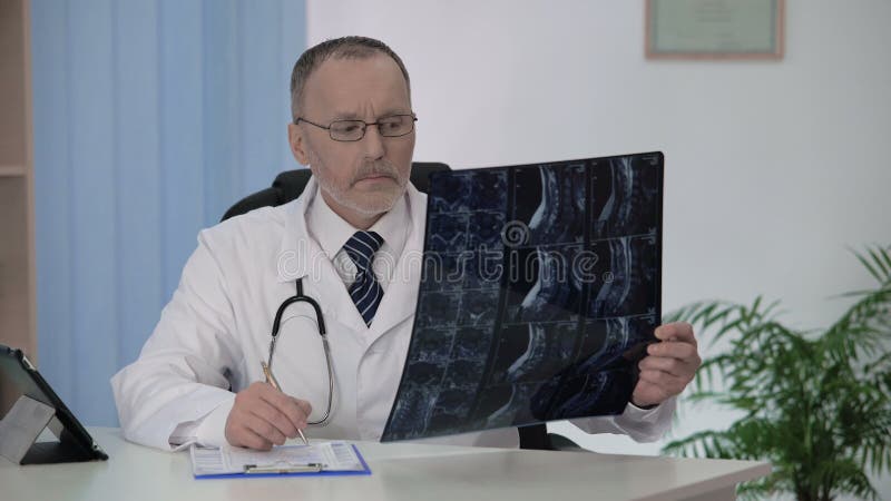 Spinal Surgeon Examining Backbone Mri, Making Notes in Patient S ...