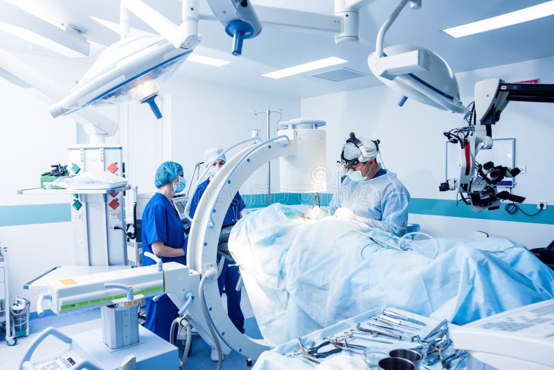 Spinal Surgery. Group of Surgeons in Operating Room with Surgery ... Spinal Surgery. Group of Surgeons in Operating Room with Surgery ...