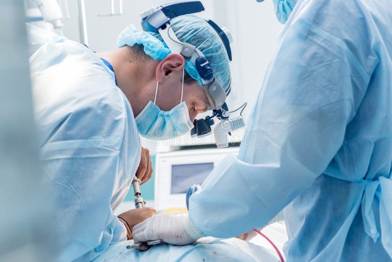 Spinal Surgery. Group of Surgeons in Operating Room with Surgery ...