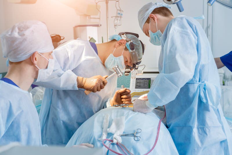 Spinal Surgery. Group of Surgeons in Operating Room with Surgery ... Spinal Surgery. Group of Surgeons in Operating Room with Surgery ...