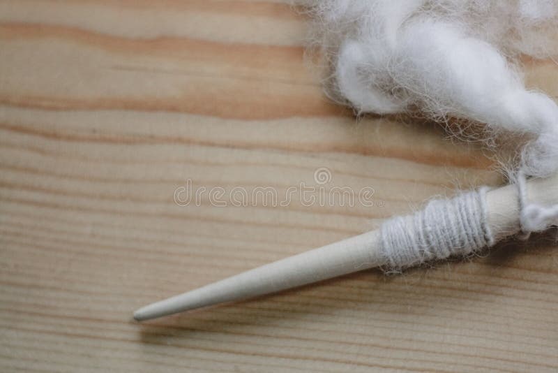 Spindle and Wool on Wood Background. the Concept of Crafting Hands-on ...