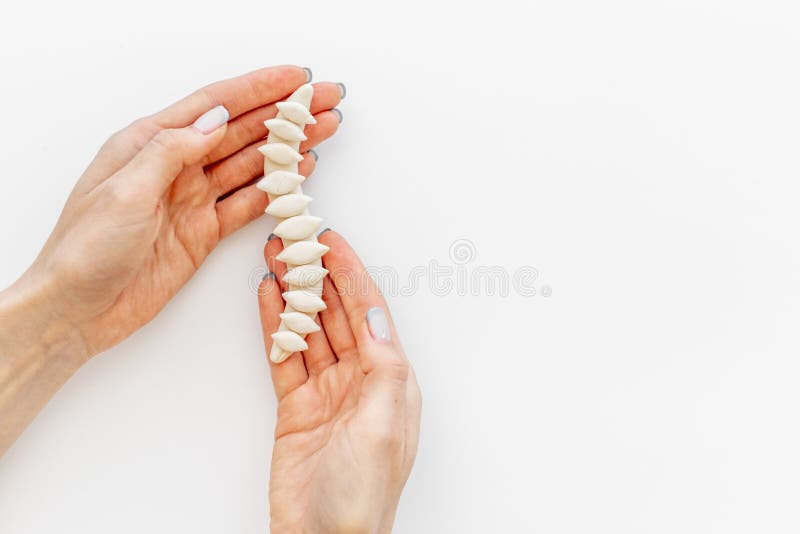Spine Skeleton Model in Hands. Spinal Diseases Curvature Concept Stock ...