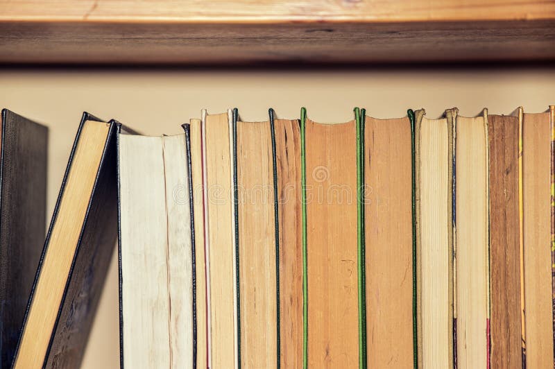 The Spines of Old Books on a Wooden Shelf Side View. Old Books ...