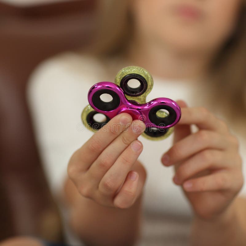 Spinner Concept. Little Girl Playing with Green Spinner at Home ...