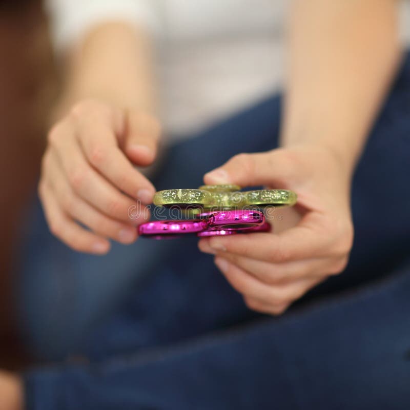 Spinner Concept. Two Spinners Green and Pink in Child`s Hands Closeup ...