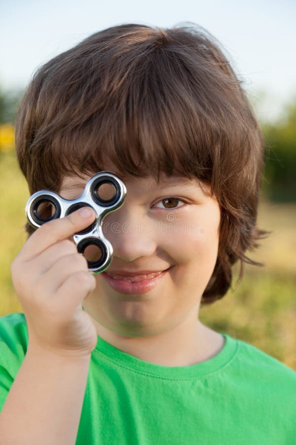 Spinner in the Hand of a Child Smiling in the Nature on a Summer Stock ...