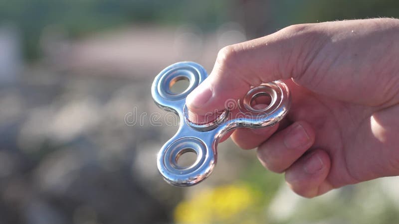 Spinner Stress Relieving Mania. the Man`s Hand is Held by a Spinning ...